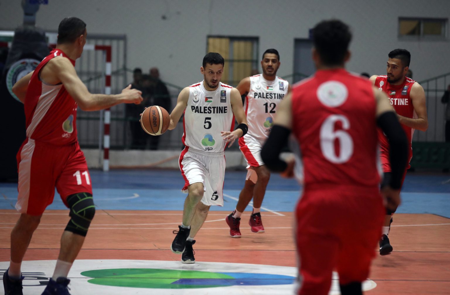 find-out-why-this-palestinian-player-is-standing-atop-a-basketball-rim